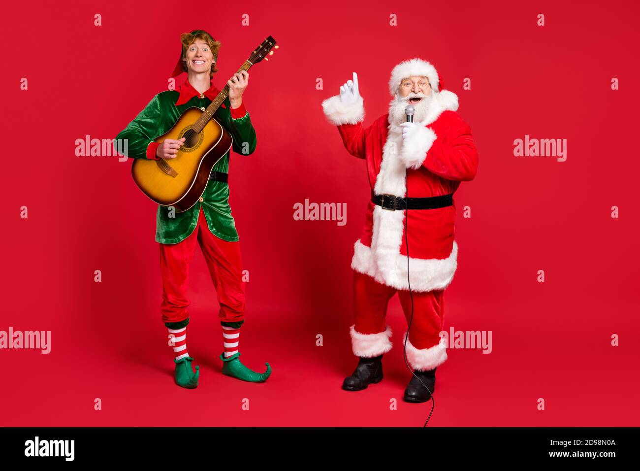 Photo of two funky men elf hold guitar santa sing mic wear x-mas ...
