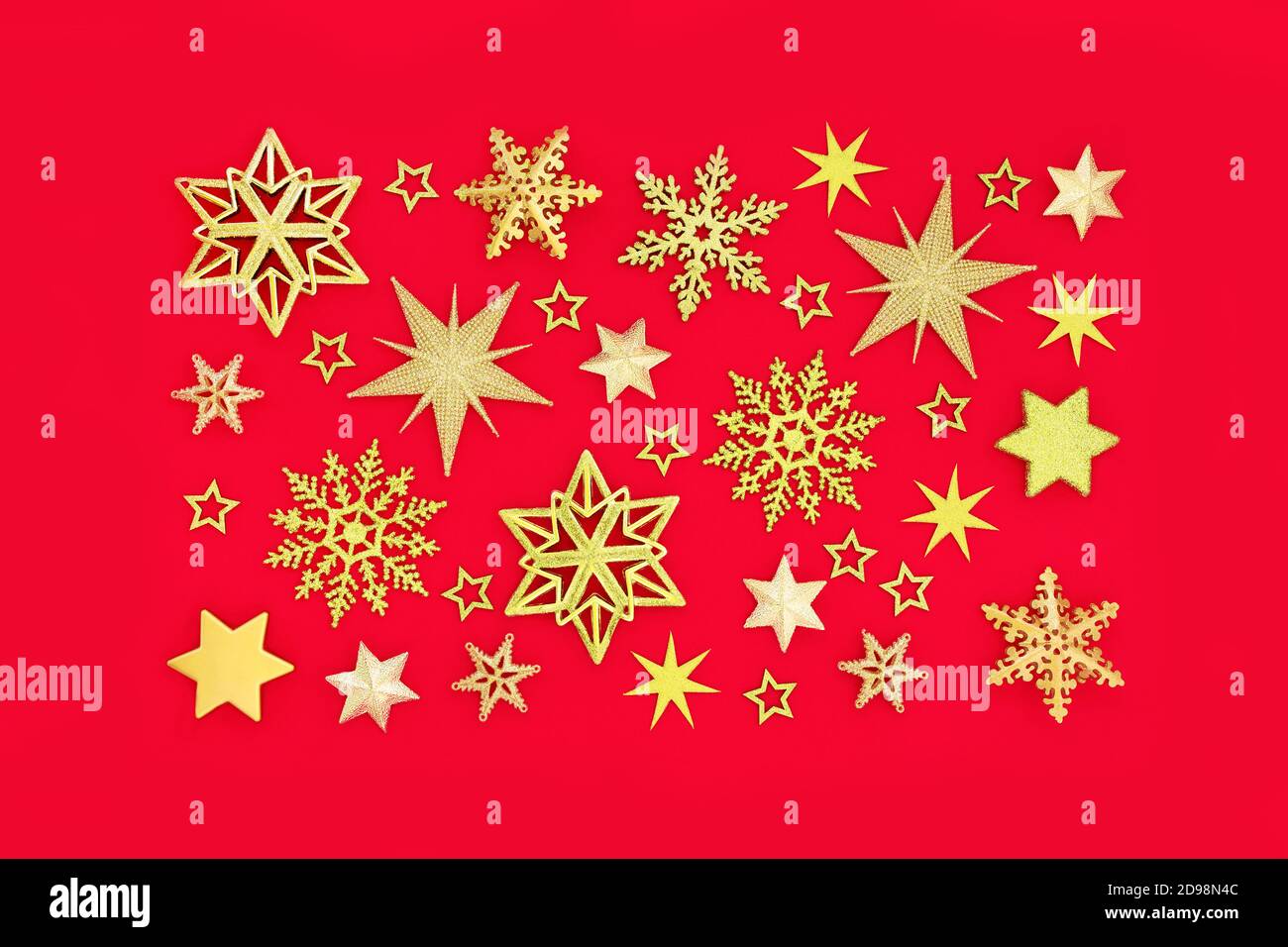 Christmas gold snowflake & star composition on red background. Abstract ...