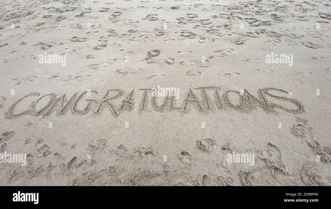 Congratulations written in the sand on a beach Stock Photo - Alamy