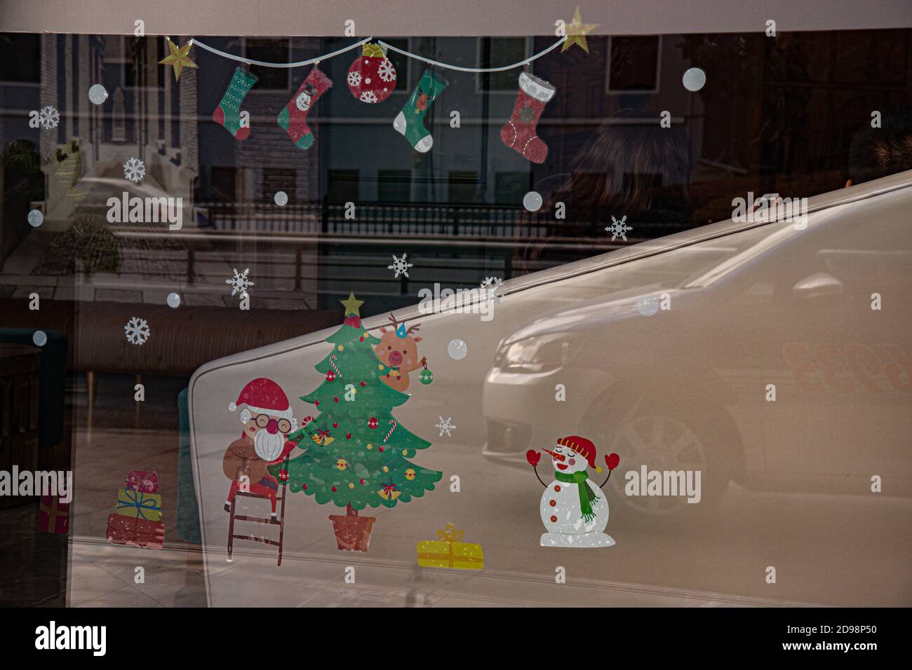 Blur reflections in glass window with holiday patterns and funny Santa ...