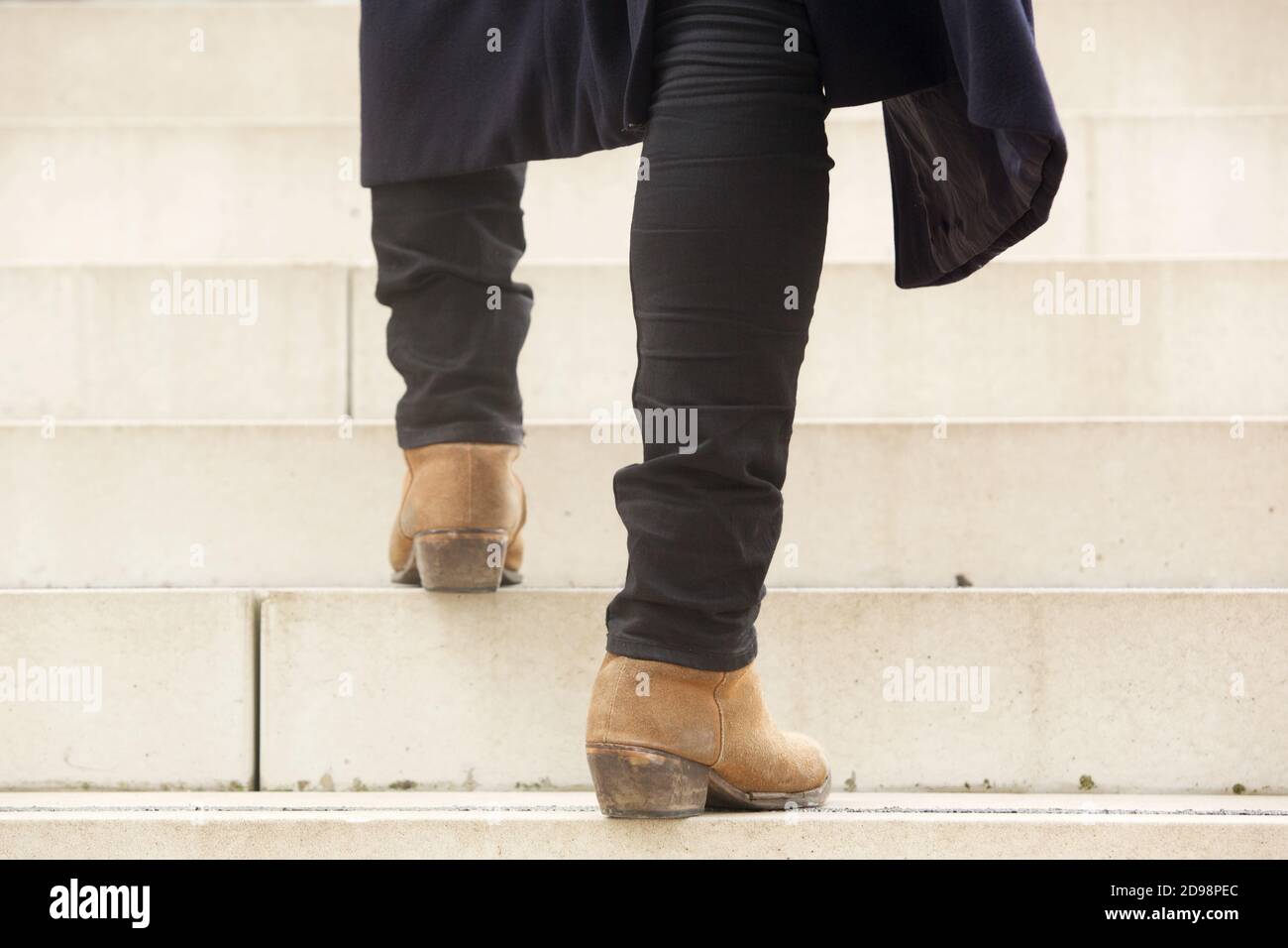 Close up behind of man walking up stairs in boots Stock Photo - Alamy