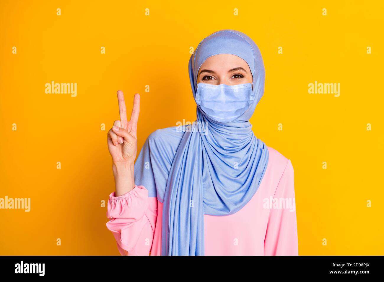 Close-up portrait of nice attractive cheerful muslimah lady showing v ...