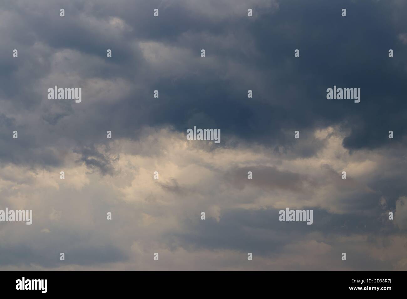 Dark blue heavy storm clouds before a thunderstorm or hurricane. Dramatic clouds in overcast ...