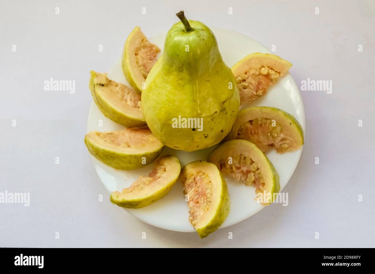 Whole and Slices of Guajava In A Small Plate Stock Photo - Alamy