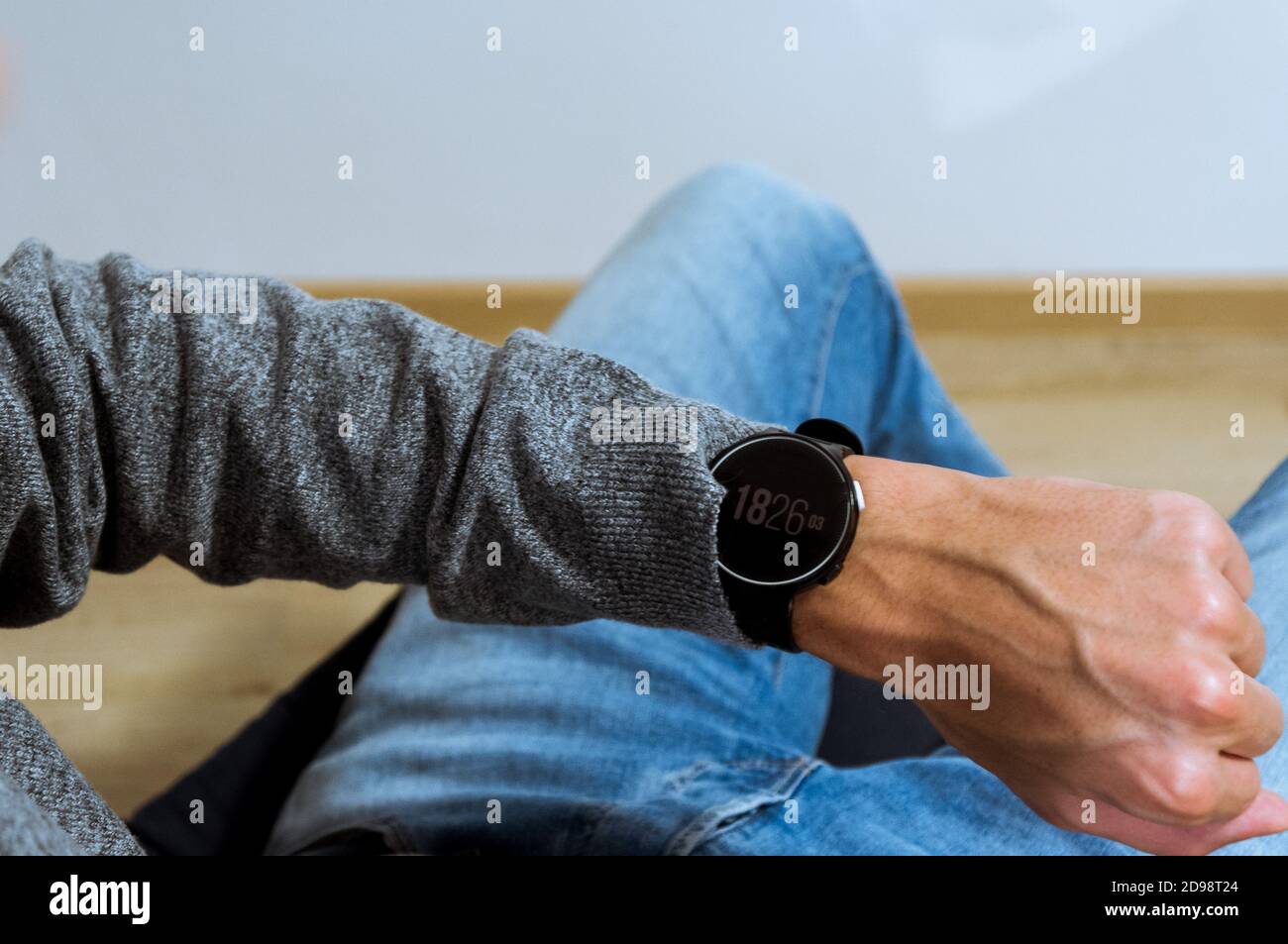 Hand wearing elegant smartwatch with clock app. over the shoulder view ...