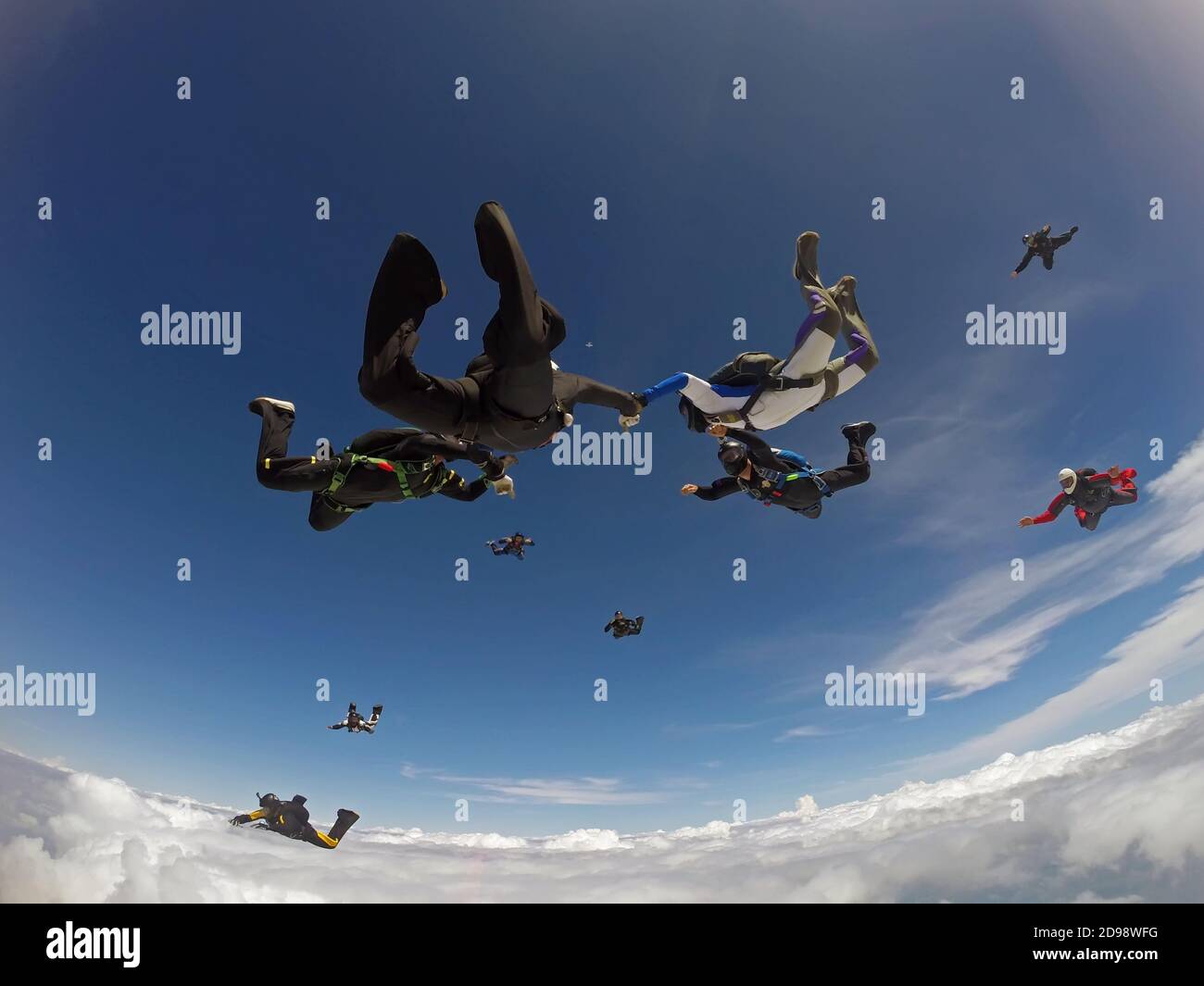 Skydiving group formation with clouds Stock Photo - Alamy