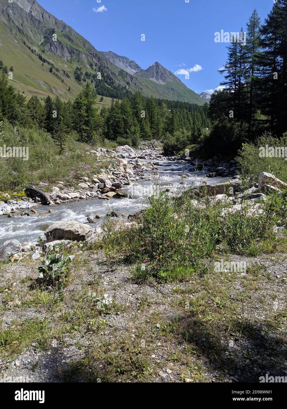 A scenic view of Alpine mountains on a beautiful sunny day. Rocky hills ...