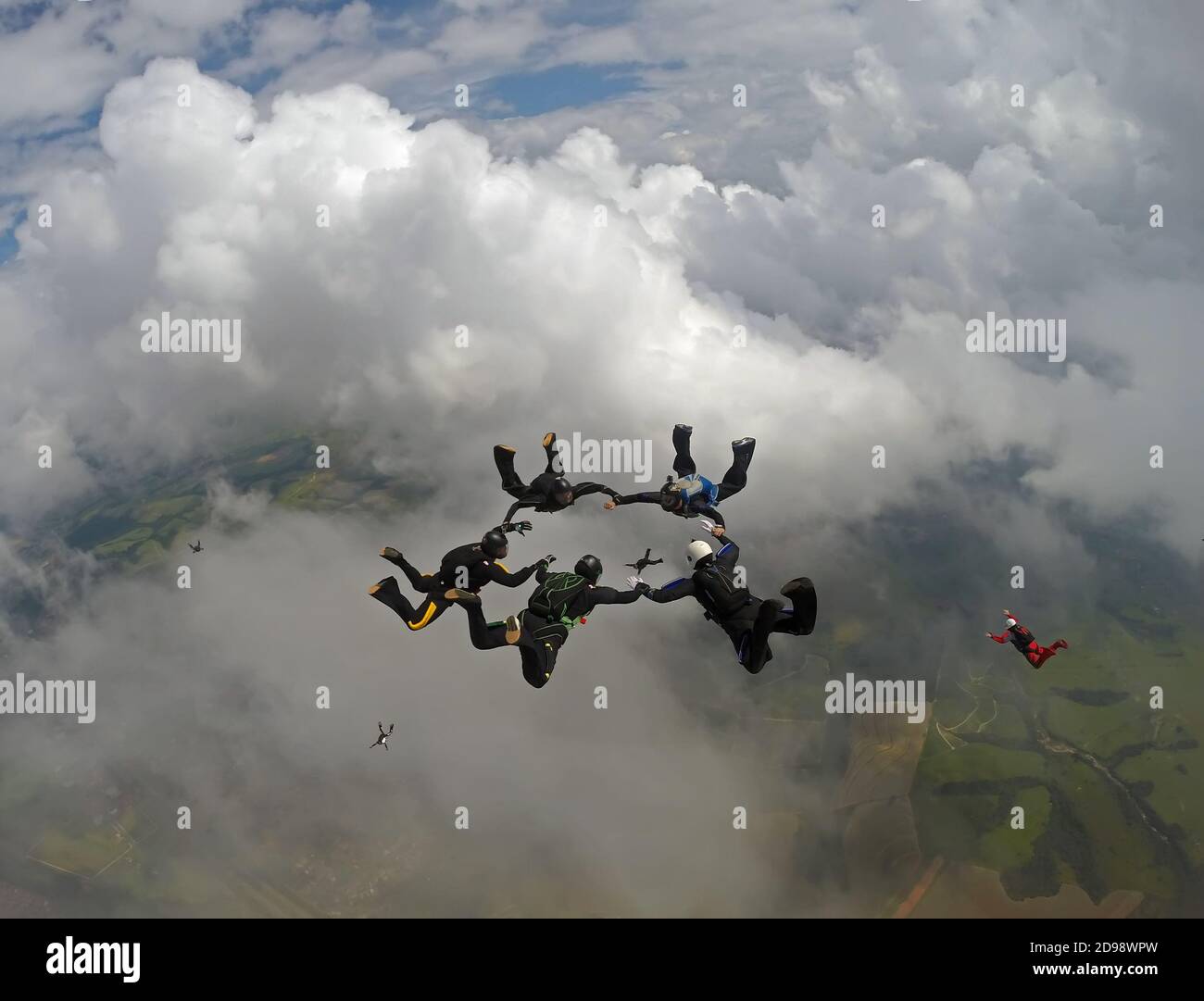 Skydiving group formation with clouds Stock Photo - Alamy
