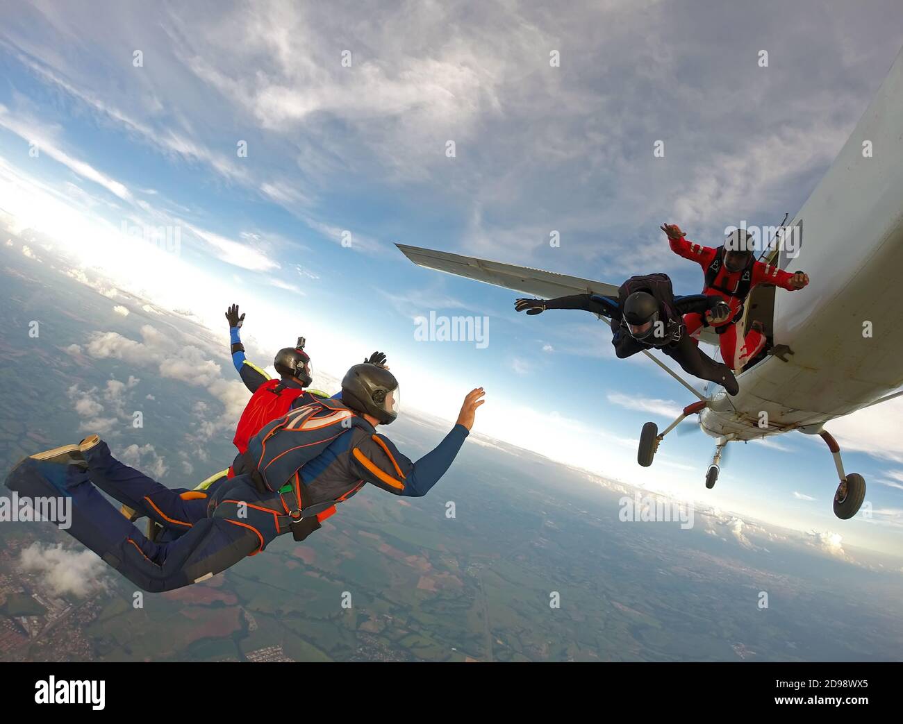 Group of skydivers jumping at the end of the day Stock Photo - Alamy