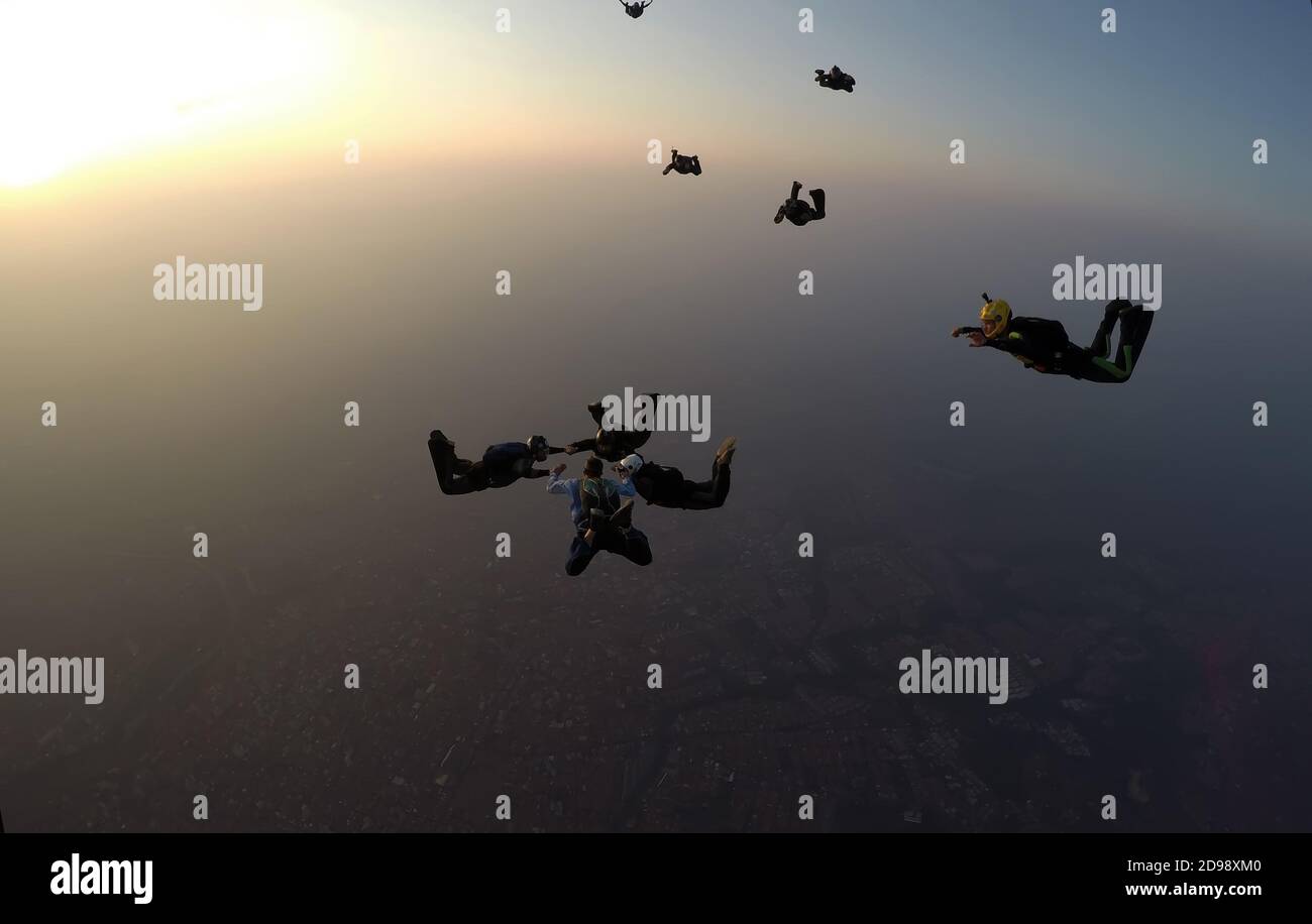 Group of skydivers jumping at the end of the day Stock Photo - Alamy
