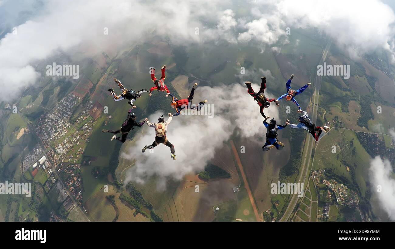 Skydiving friends holding hands Stock Photo - Alamy