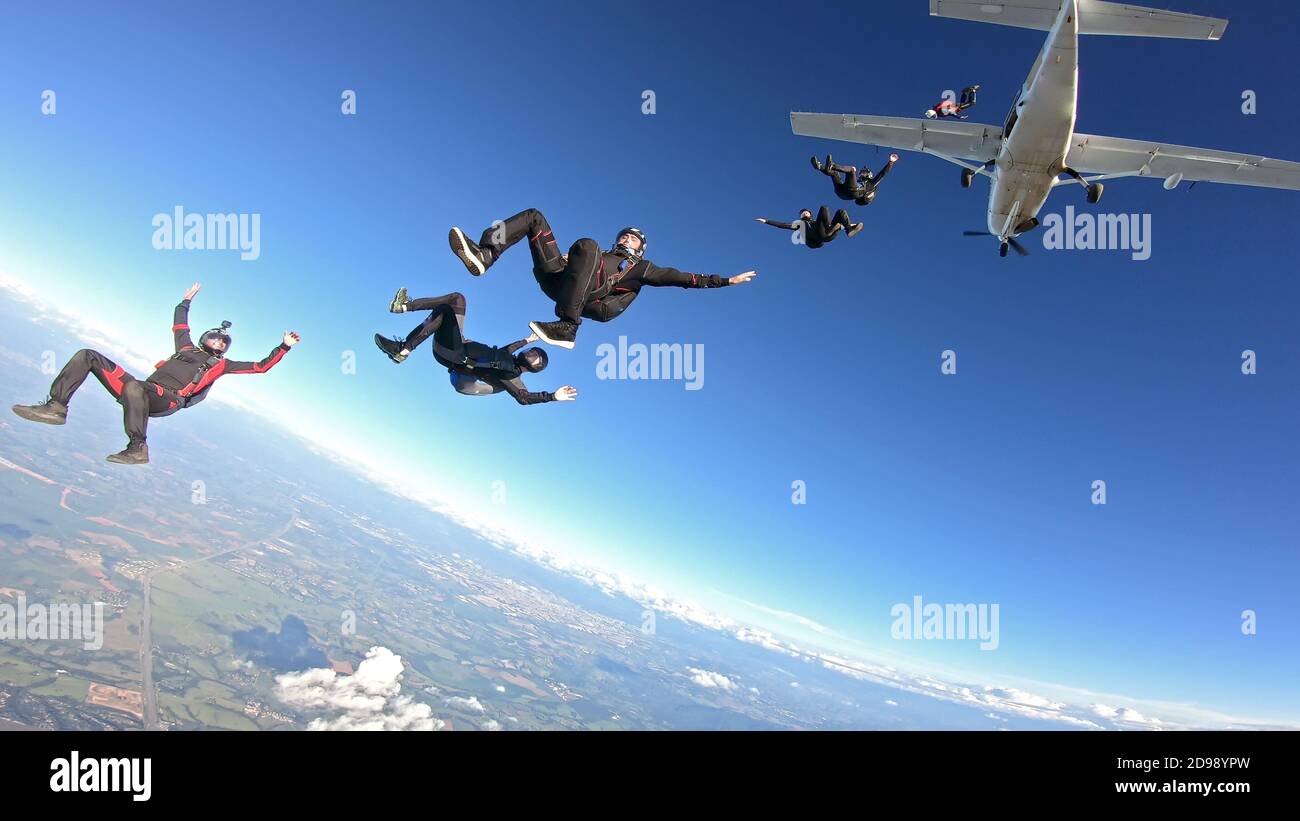 Skydivers having fun jumping out the plane Stock Photo - Alamy