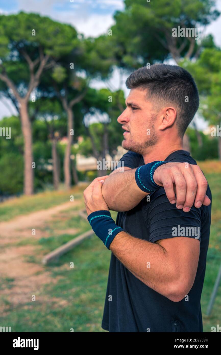 Vertical shot of a handsome sportsman in a park during training Stock ...