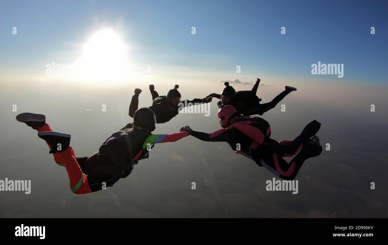 Group of skydivers jumping at the end of the day Stock Photo - Alamy