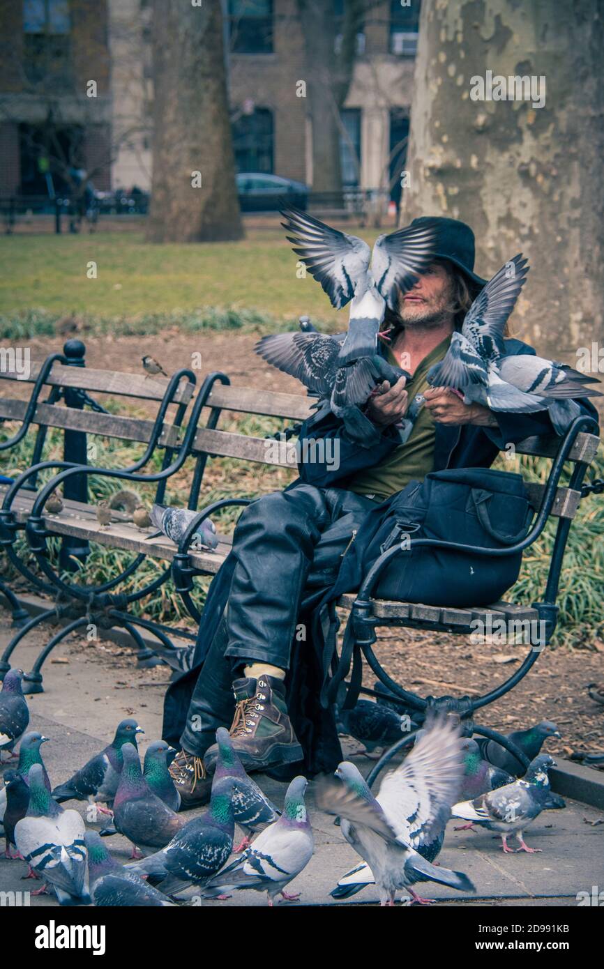 Larry Reddick, known as Larry the Birdman, feeding a flock of pigeons ...