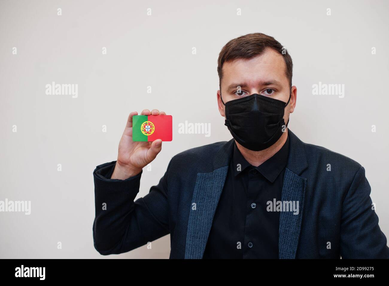 European man wear black formal and protect face mask, hold Portugal ...