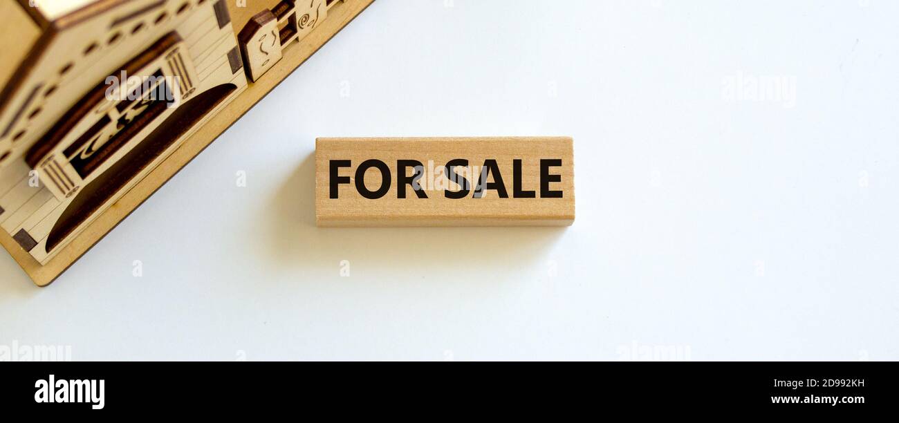 Wooden block with words 'for sale' near miniature house. Beautiful ...