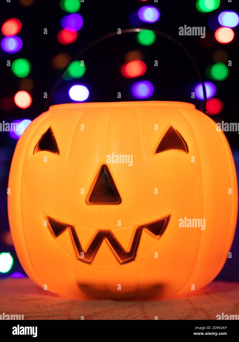 Halloween pumpkin under lights with bokeh Stock Photo - Alamy