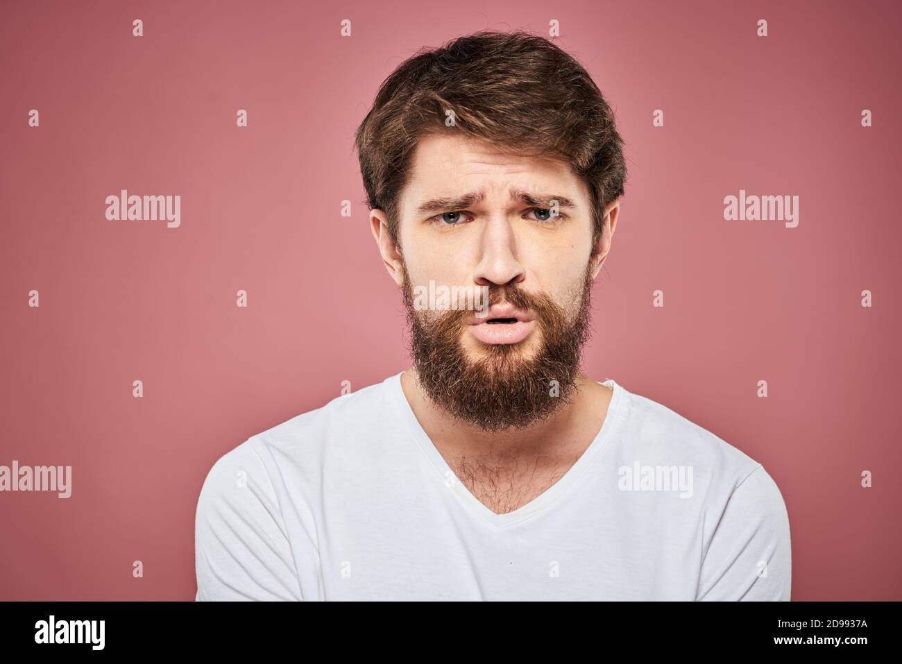 emotional man white t shirt sad facial expression pink background Stock ...