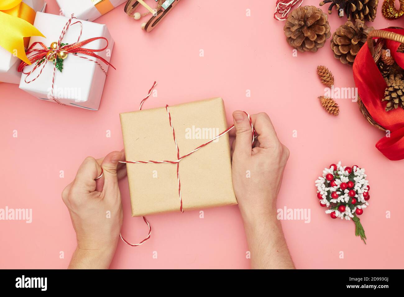 Merry Christmas gift wrapping step by step, decorations on pink ...