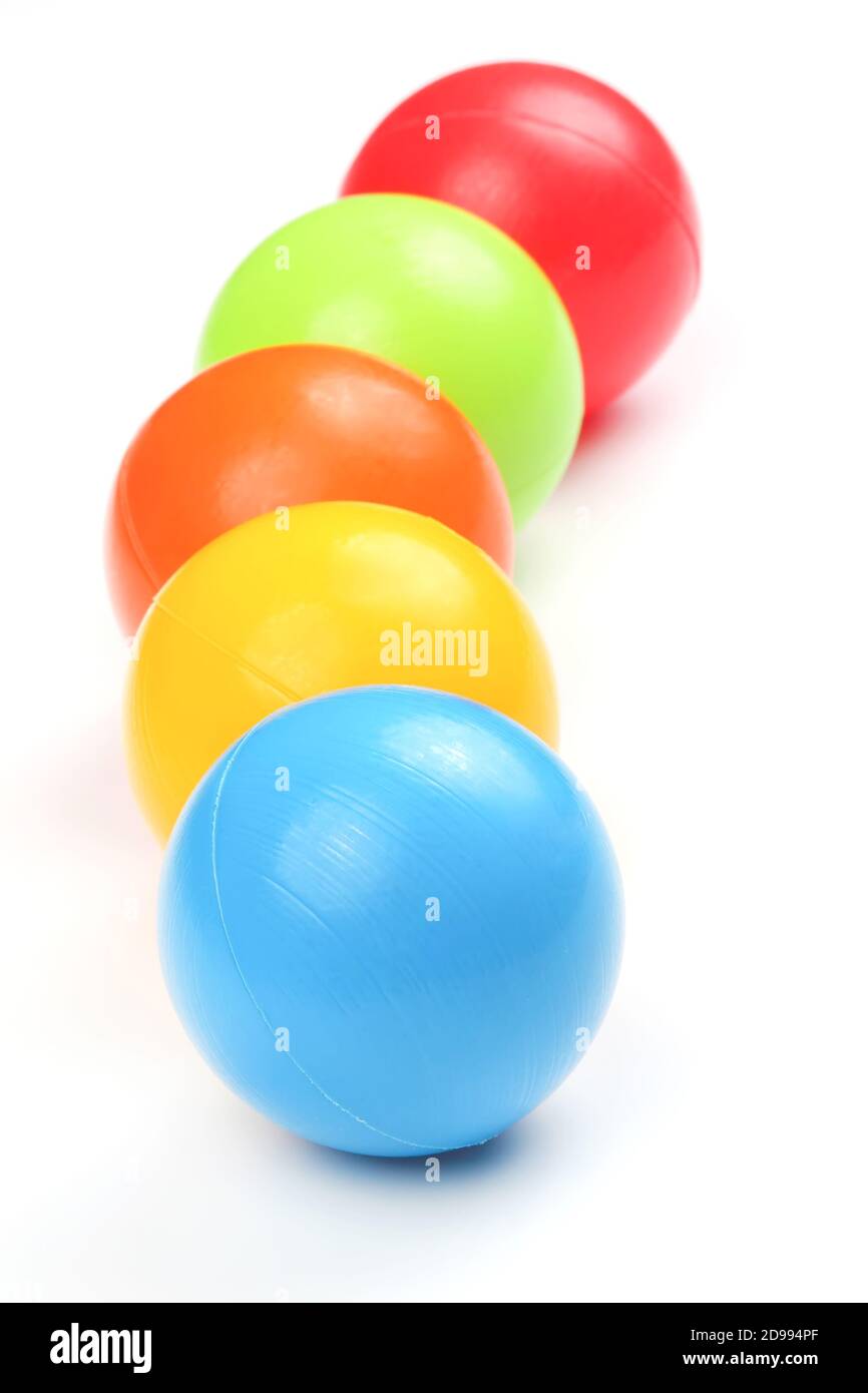Colored plastic balls on white background Stock Photo - Alamy