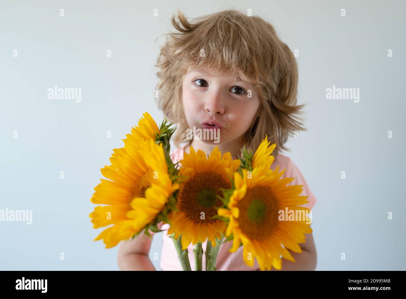 Kid with flowers. Lovely romantic child. Funny kids face Stock Photo ...