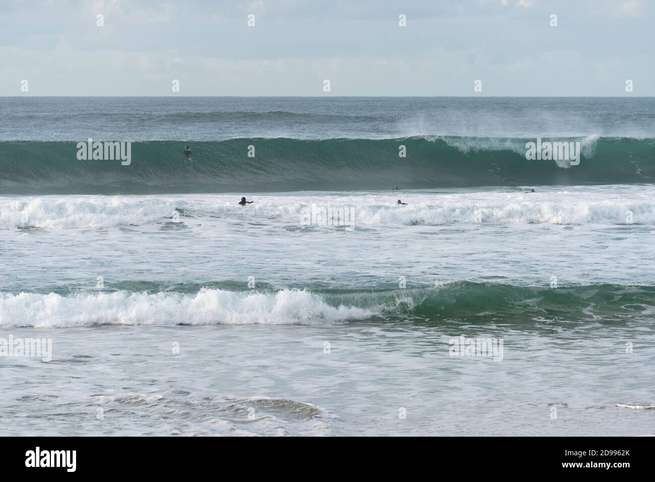 Surfers surfing in Baleal Island beach atlantic ocean waves in Peniche ...