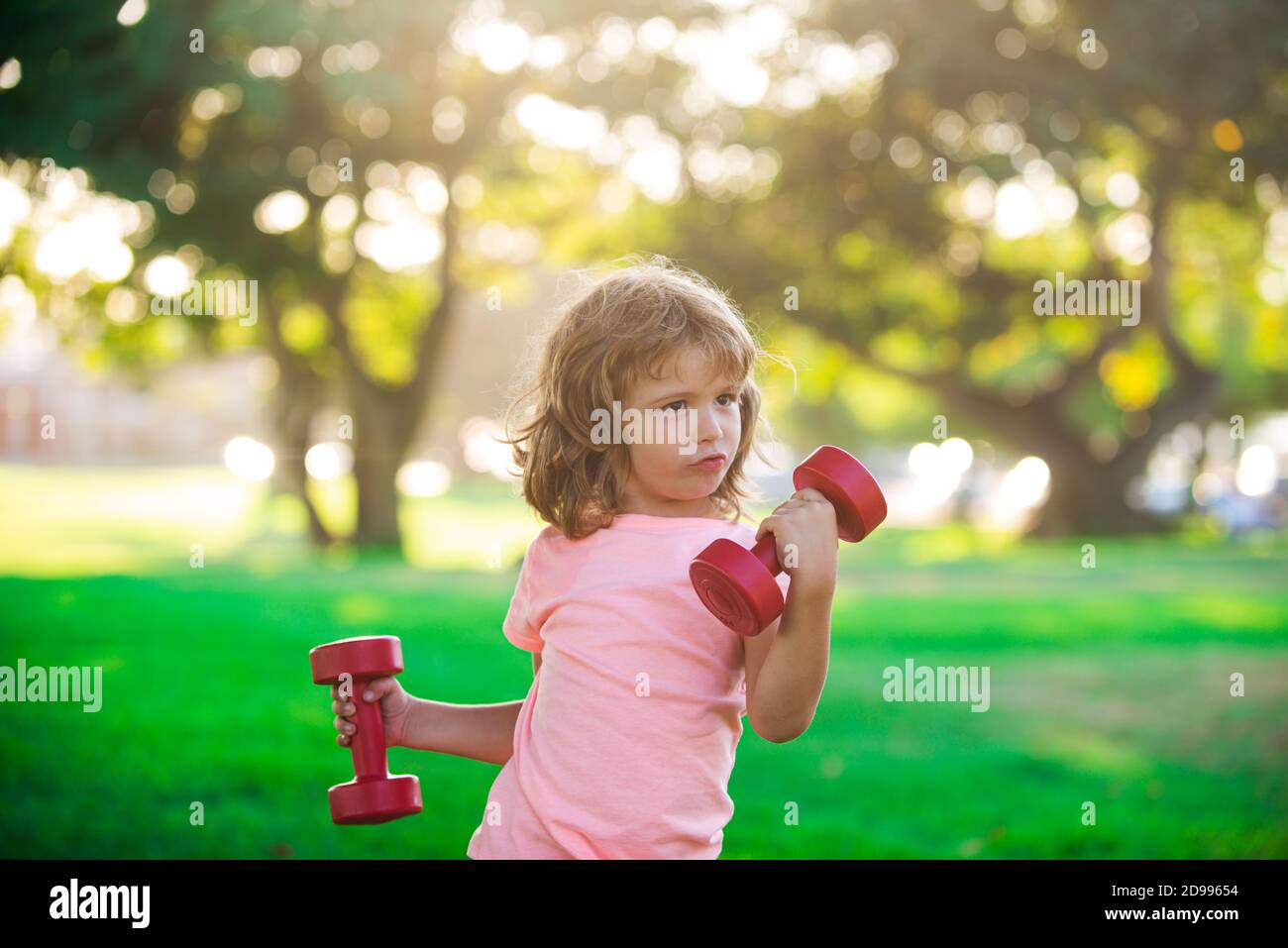 Kids exercising in park. Active boy, healthy lifestyle. Sport child boy with strong biceps ...