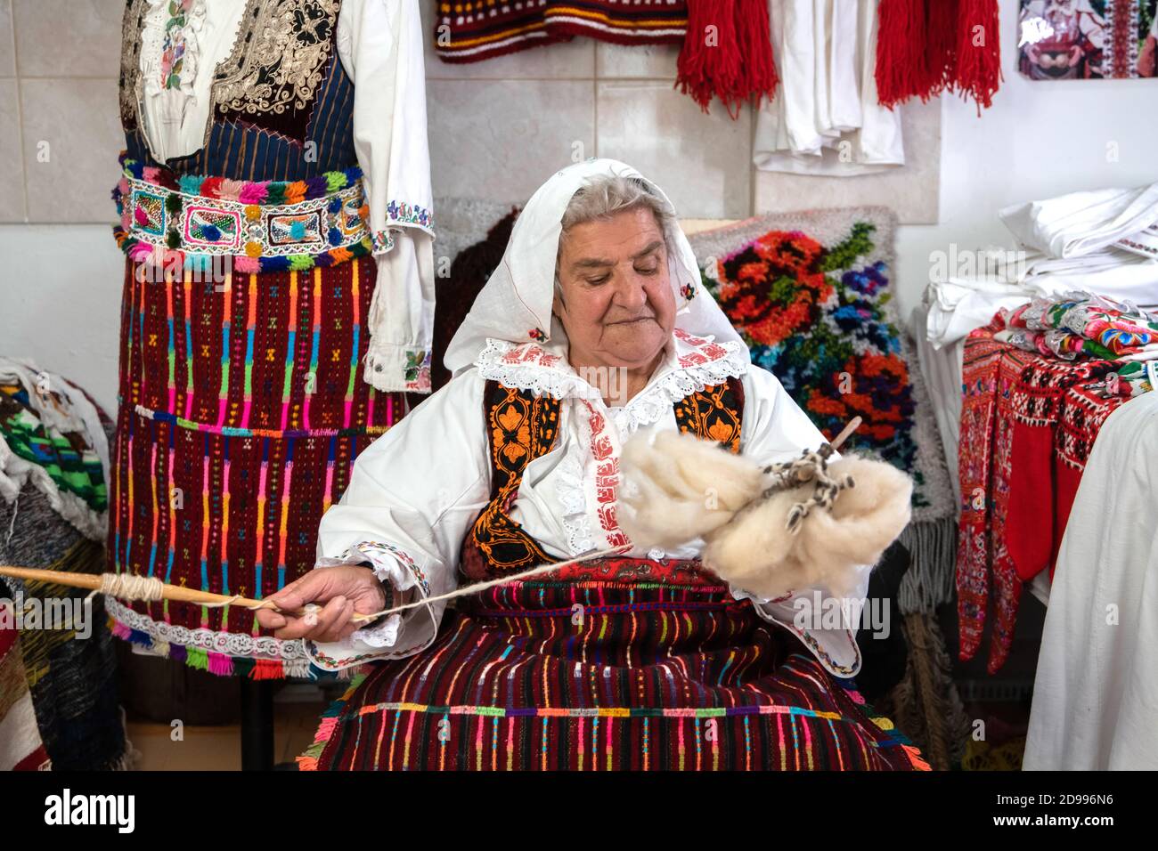 An old woman weaver spun wool on her hand. An old extinct craft Stock ...
