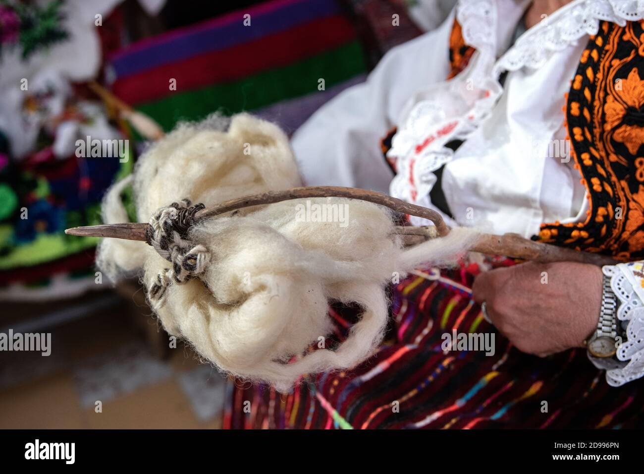 An old woman weaver spun wool on her hand. An old extinct craft Stock ...