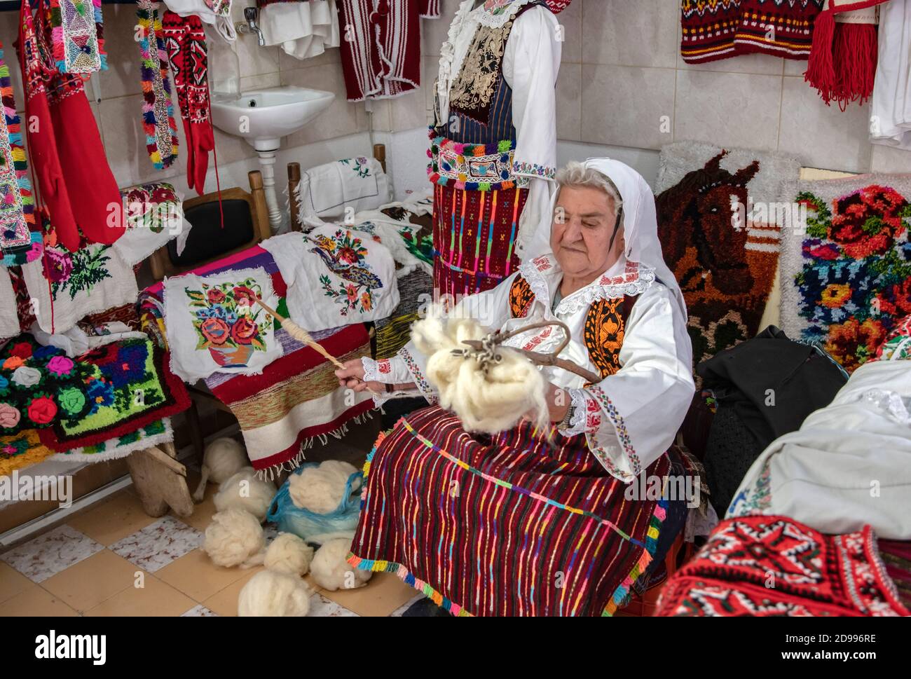 An old woman weaver spun wool on her hand. An old extinct craft Stock ...
