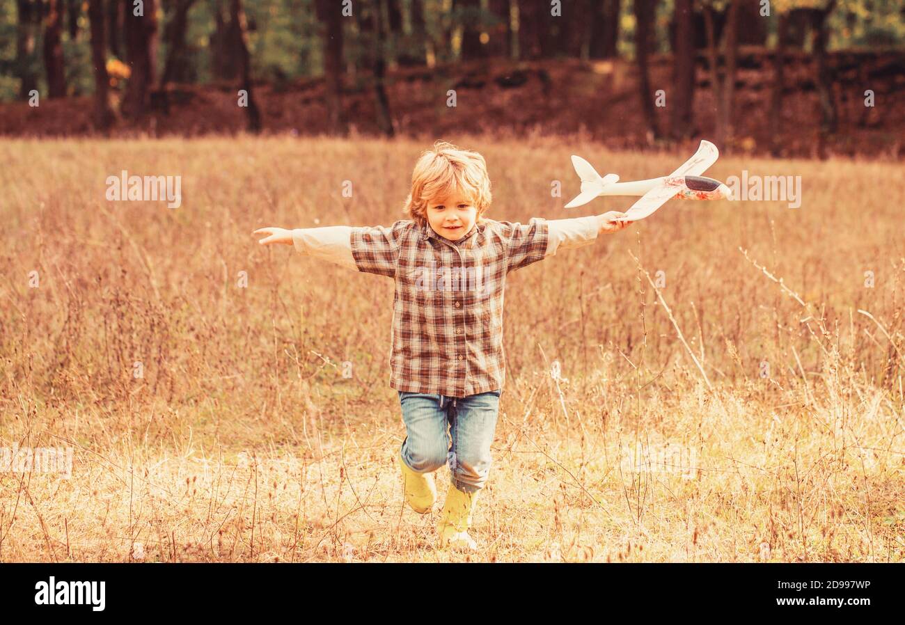 Little kid dreams of being a pilot. Happy boy play airplane. Little boy ...
