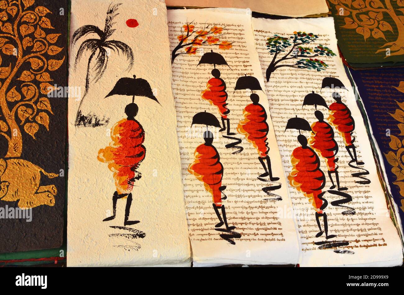 Luang Prabang, Laos - March 23, 2018: Souvenir painted orange monks on ...