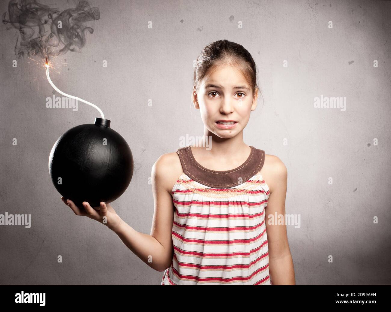 scared little girl holding an old-fashioned bomb Stock Photo - Alamy