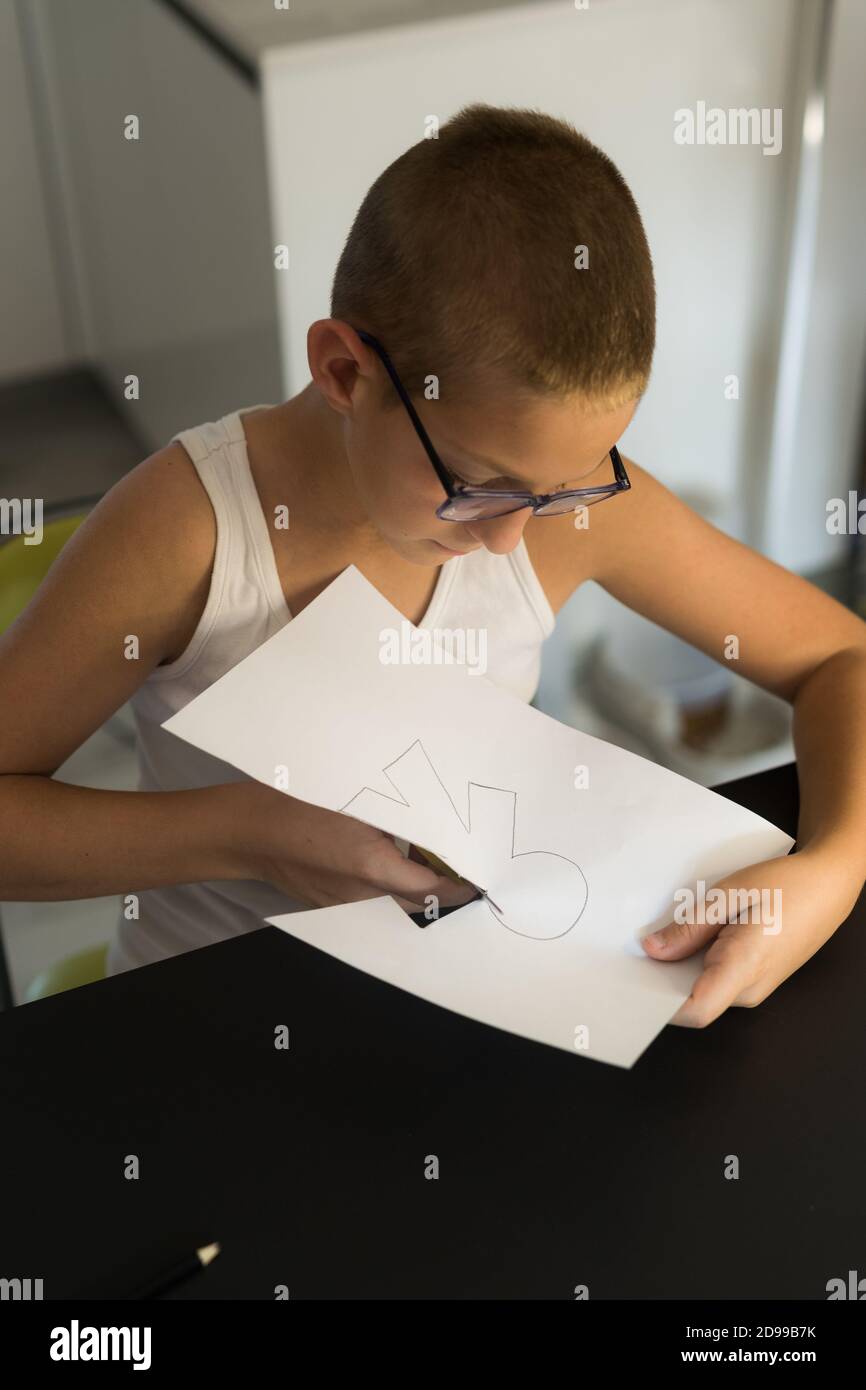 Boy cutting drawing scissors hi-res stock photography and images - Alamy