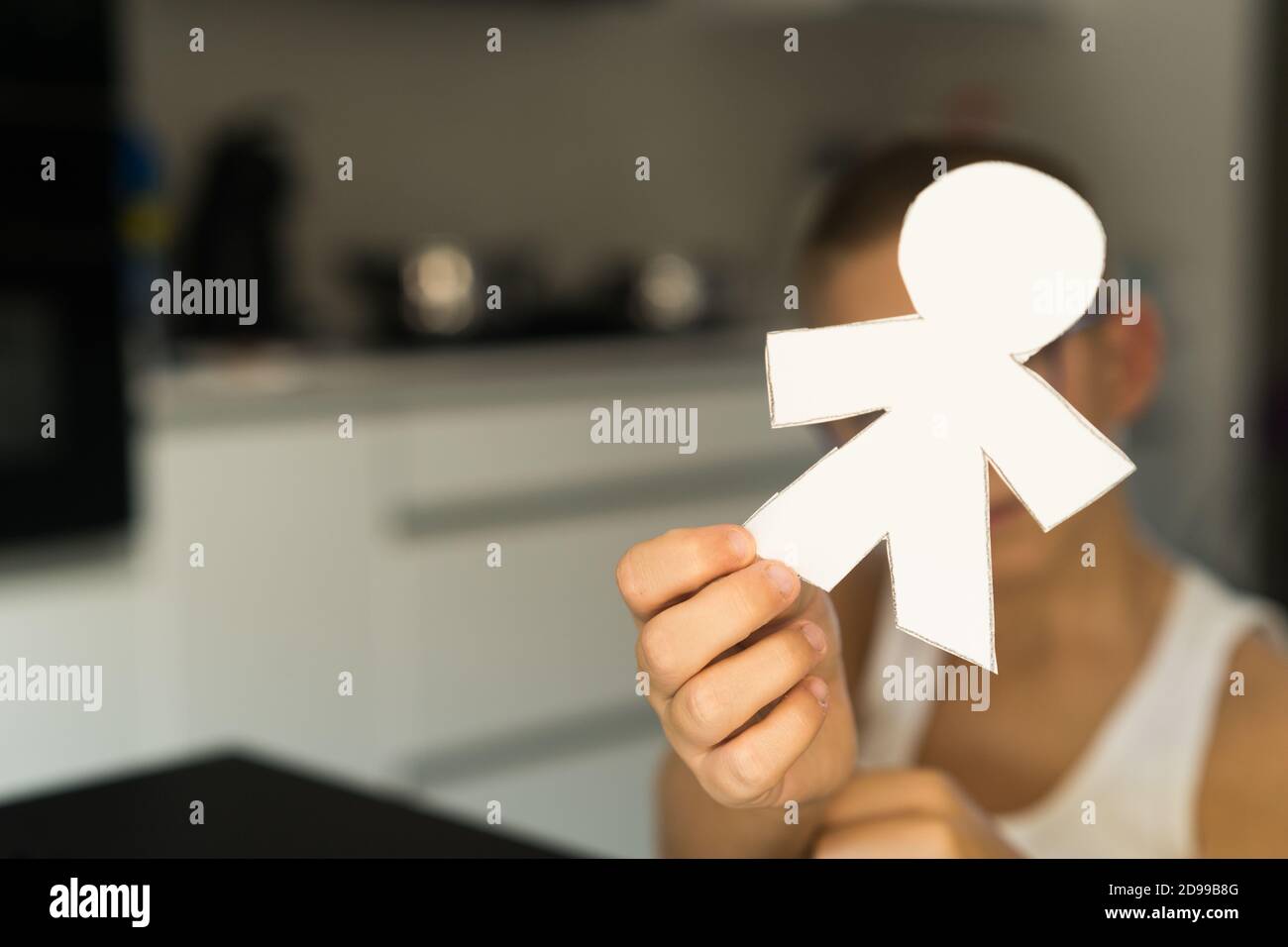 Child holding a handmade paper human Stock Photo - Alamy