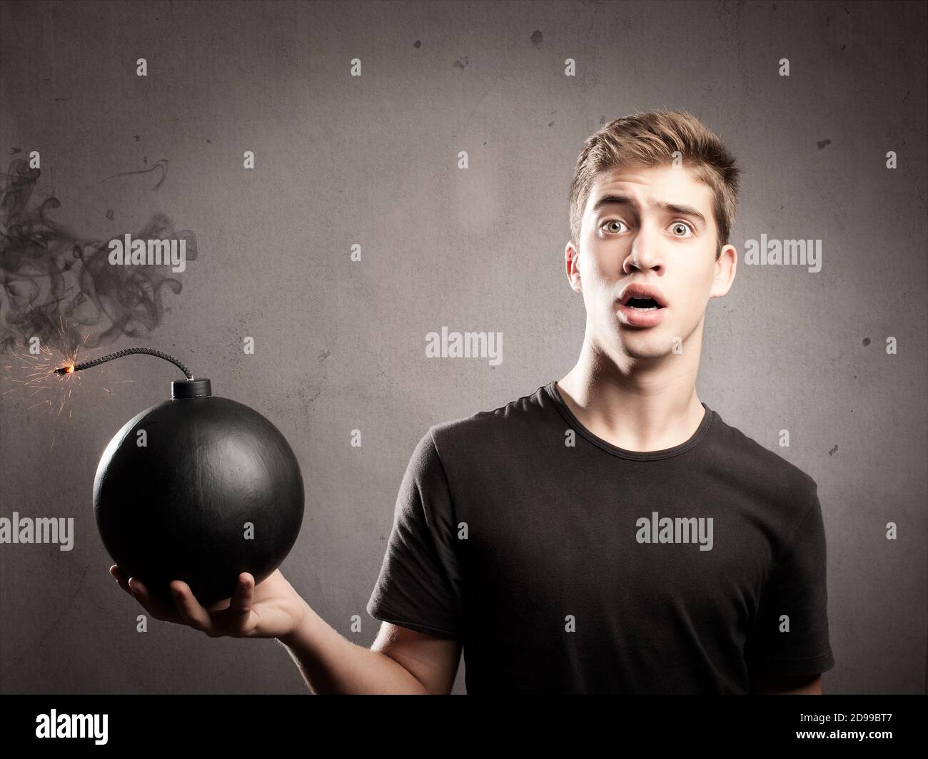 scared young man holding an old-fashioned bomb Stock Photo - Alamy