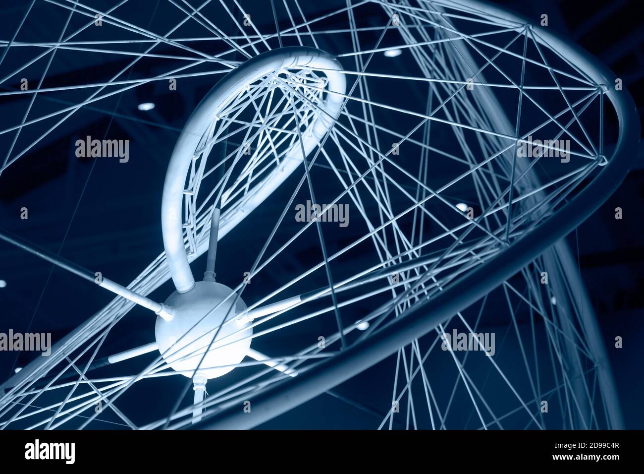 Abstract high tech photo with blue parametric steel structure over dark ...