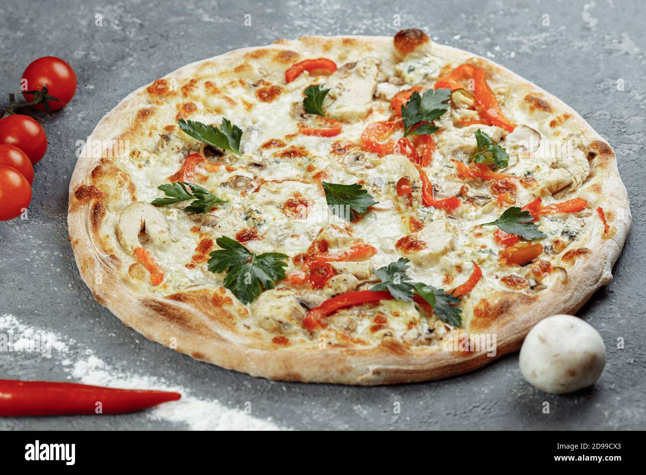 Chicken-blue pizza with tomato, mozzarella and Dor Blue cheeses on gray ...