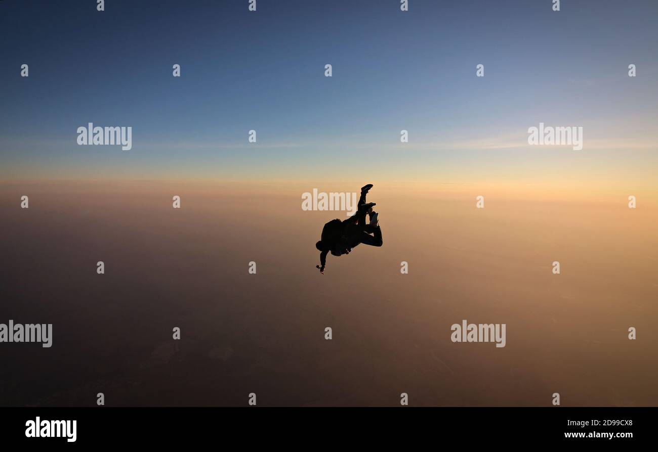 Skydiving tandem at the awesome sunset Stock Photo - Alamy