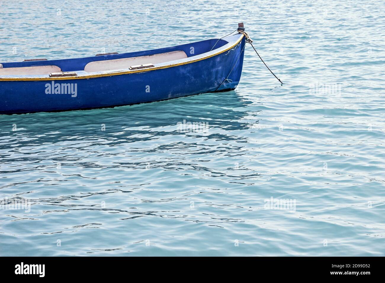 blue fishing boat floating in ocean Stock Photo - Alamy