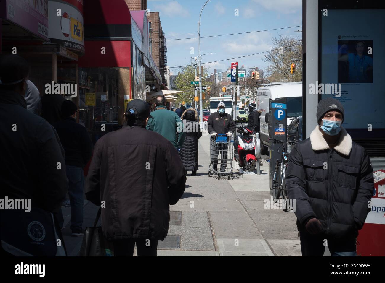 Shoppers wait patiently in line to be allowed inside a supermarket in ...