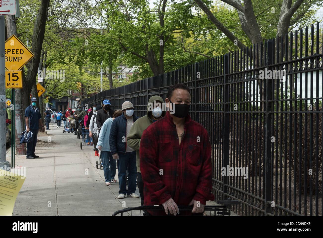 People wait in line outside a food pantry at St. Bartholomew's Roman ...