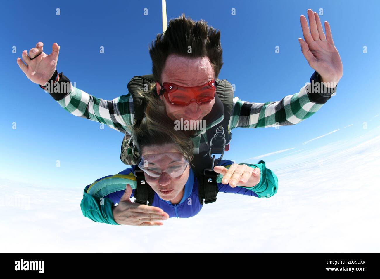 Sky diving tandem holding hands Stock Photo - Alamy