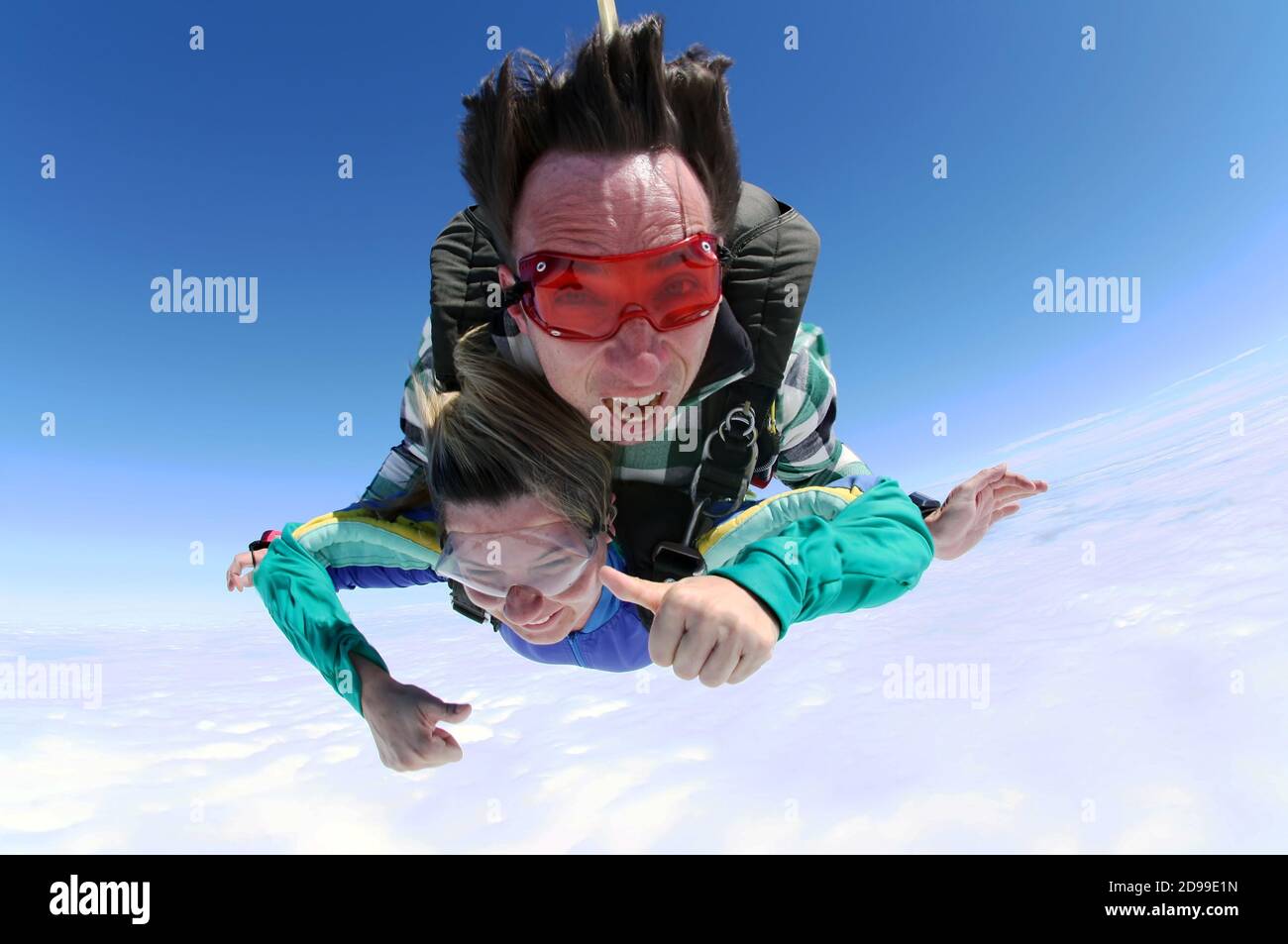 Sky diving tandem holding hands Stock Photo - Alamy