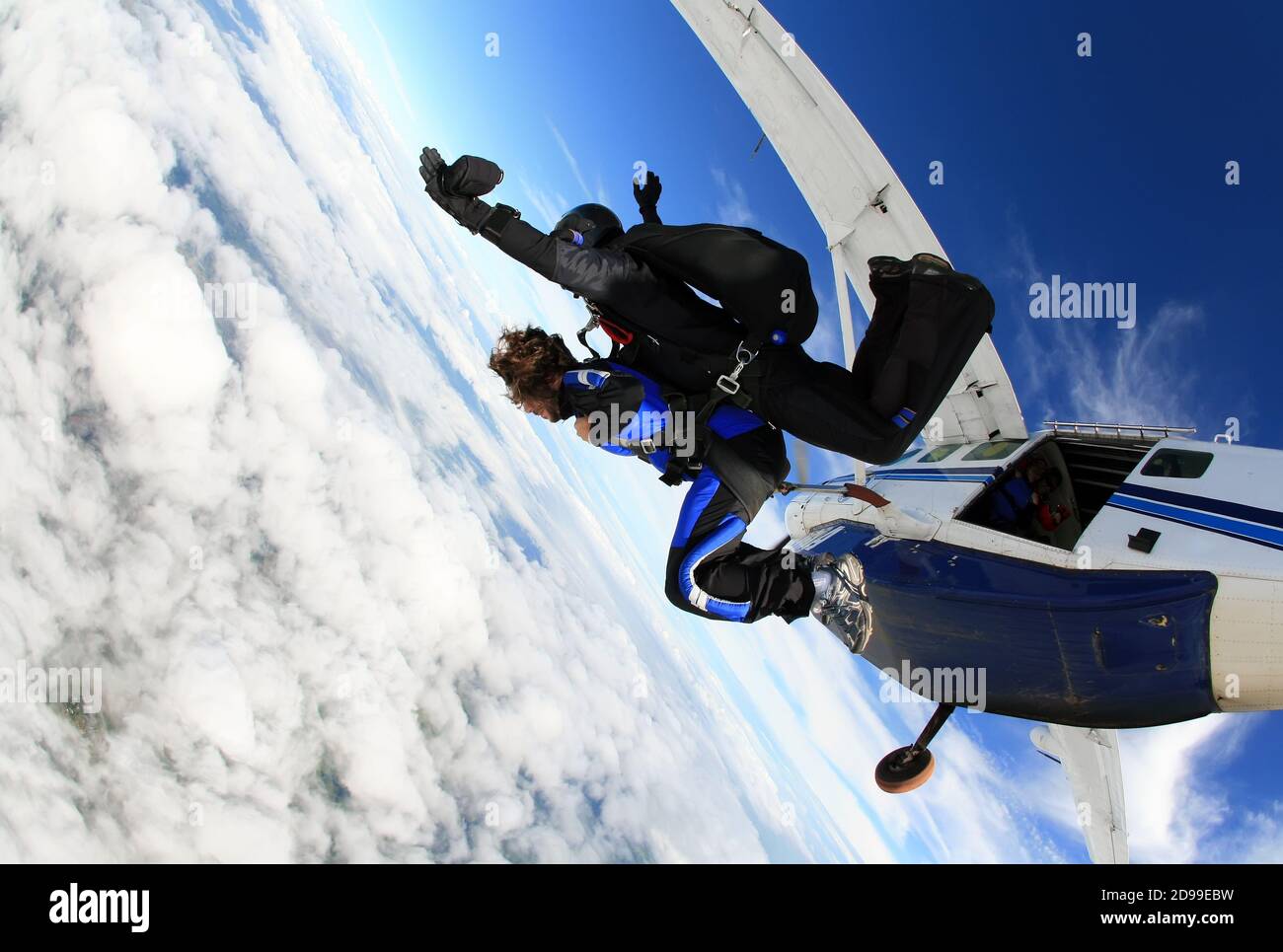 Skydiving tandem exit from the plane Stock Photo - Alamy