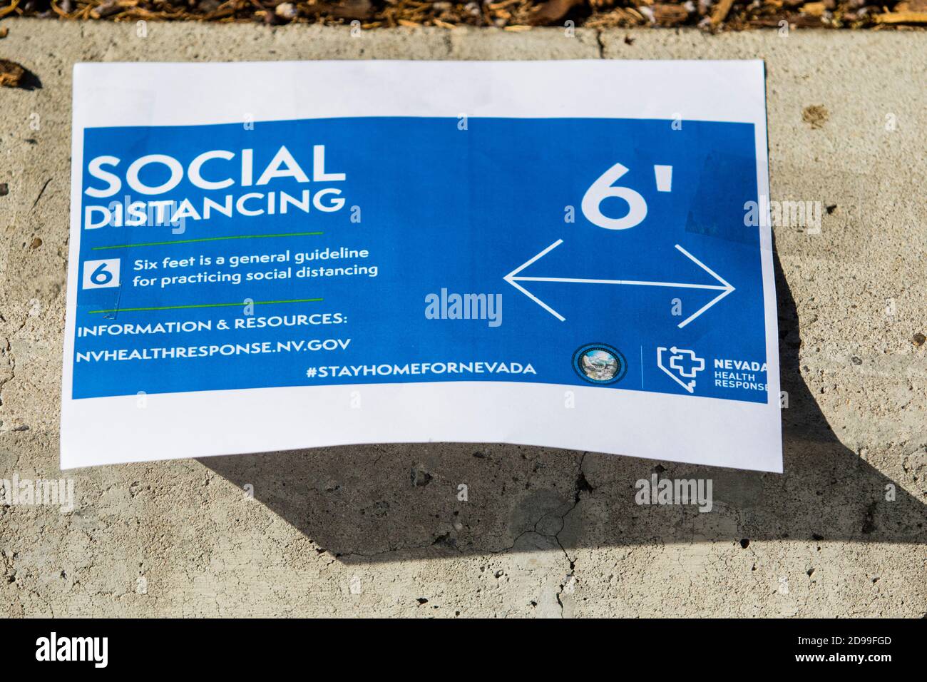 A sign asking voters to maintain social distance seen outside a polling ...