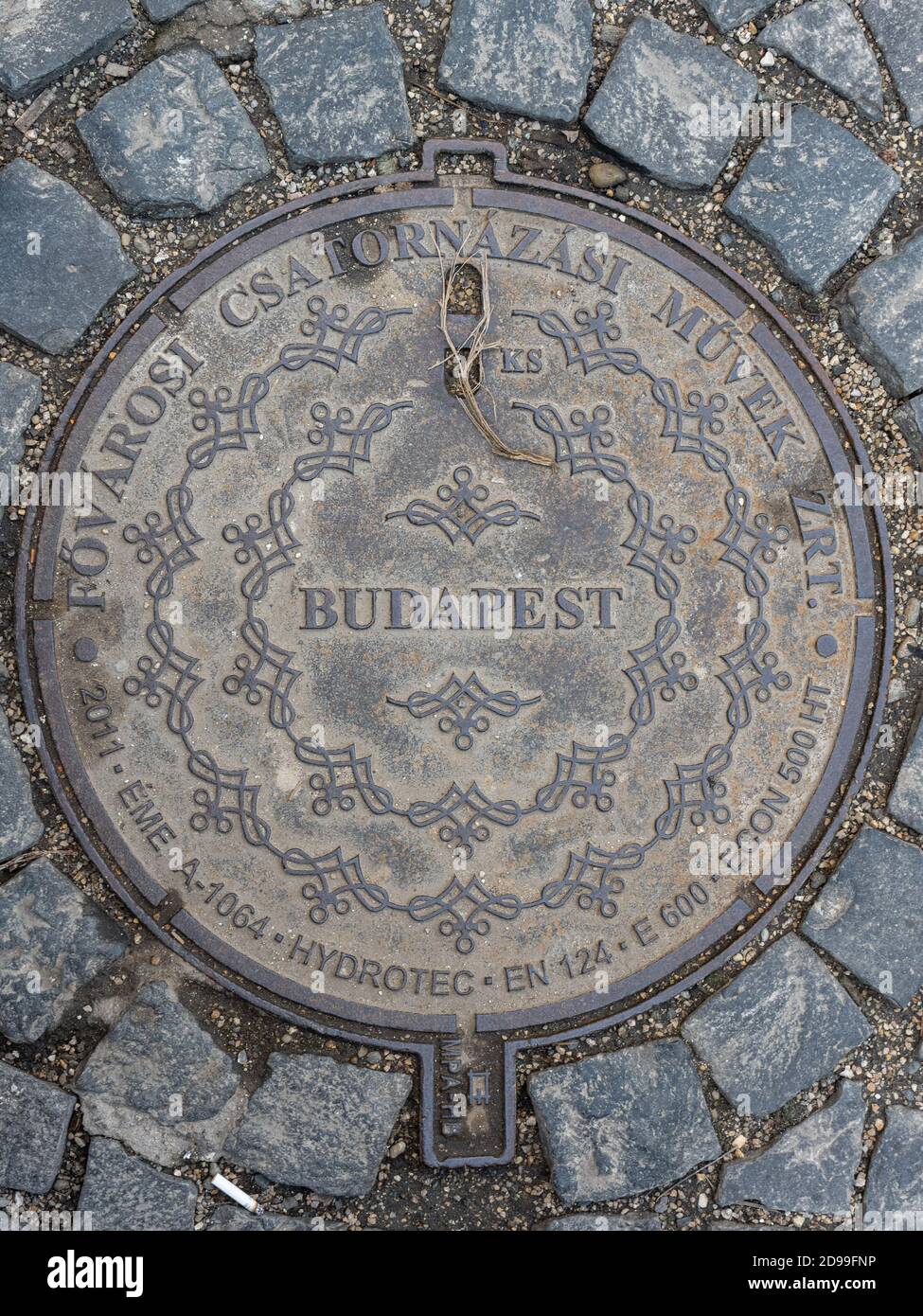 Decorative manhole cover in the cobbled streets of Budapest, Hungary ...