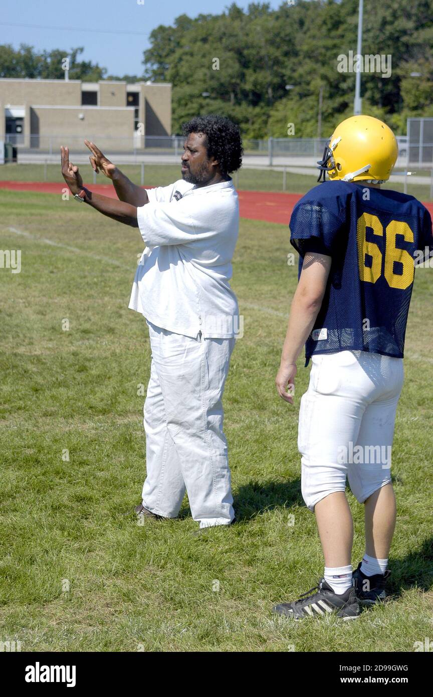 Handicapped Deaf JV football player reads sign language given by black ...