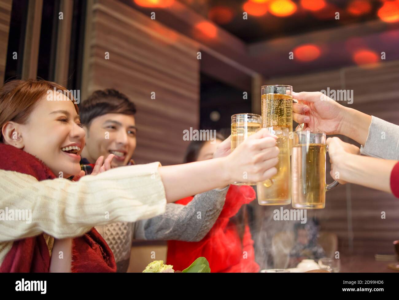 happy friends drinking and toasting beer at hot pot restaurant Stock ...